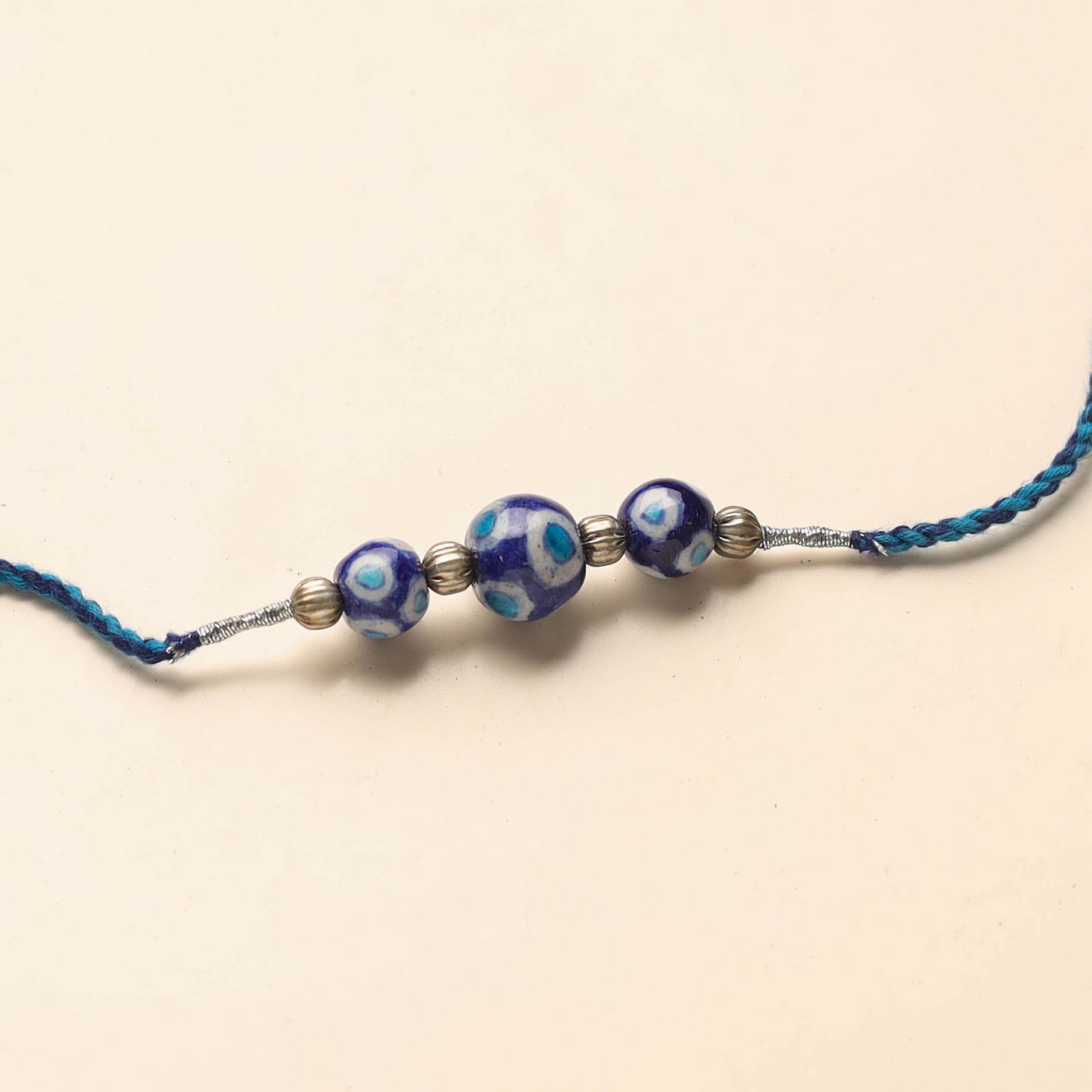 Patwa Threadwork Blue Pottery Beads Rakhi – iTokri आई.टोकरी